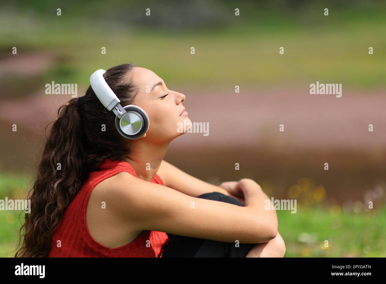 Woman in nature listening audio Stock Photo - Alamy