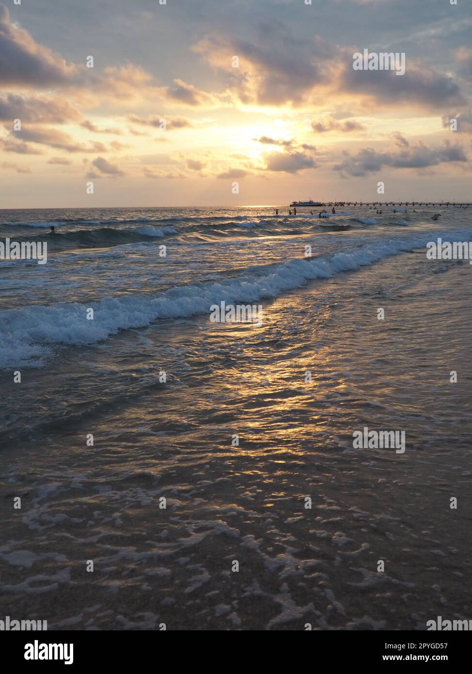 Wave and sunset over sea. Beautiful sunset. Foamy waves roll over the ...