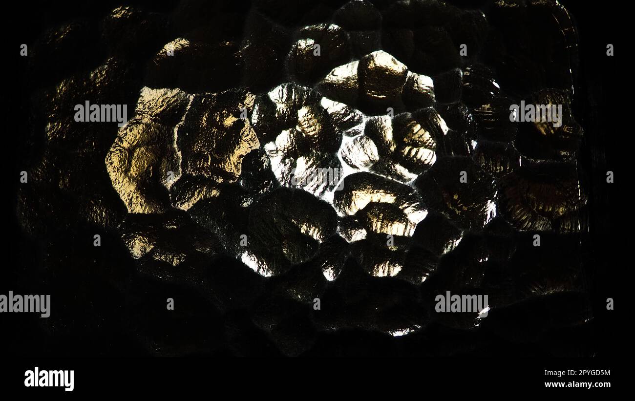 Corrugated glass, rear light source. Play of glare and reflections on a ...