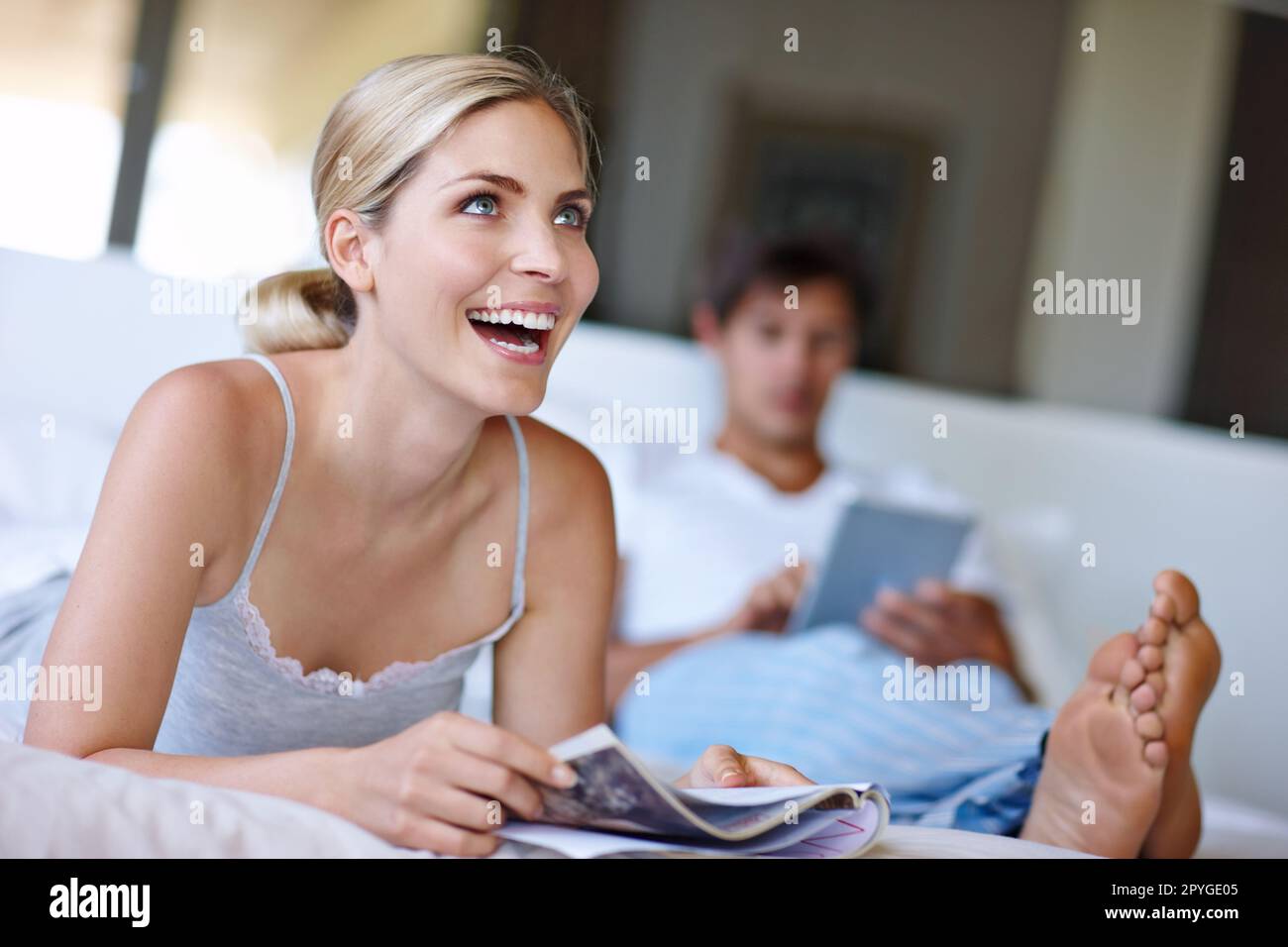 Happy young woman lying bed hi-res stock photography and images - Alamy