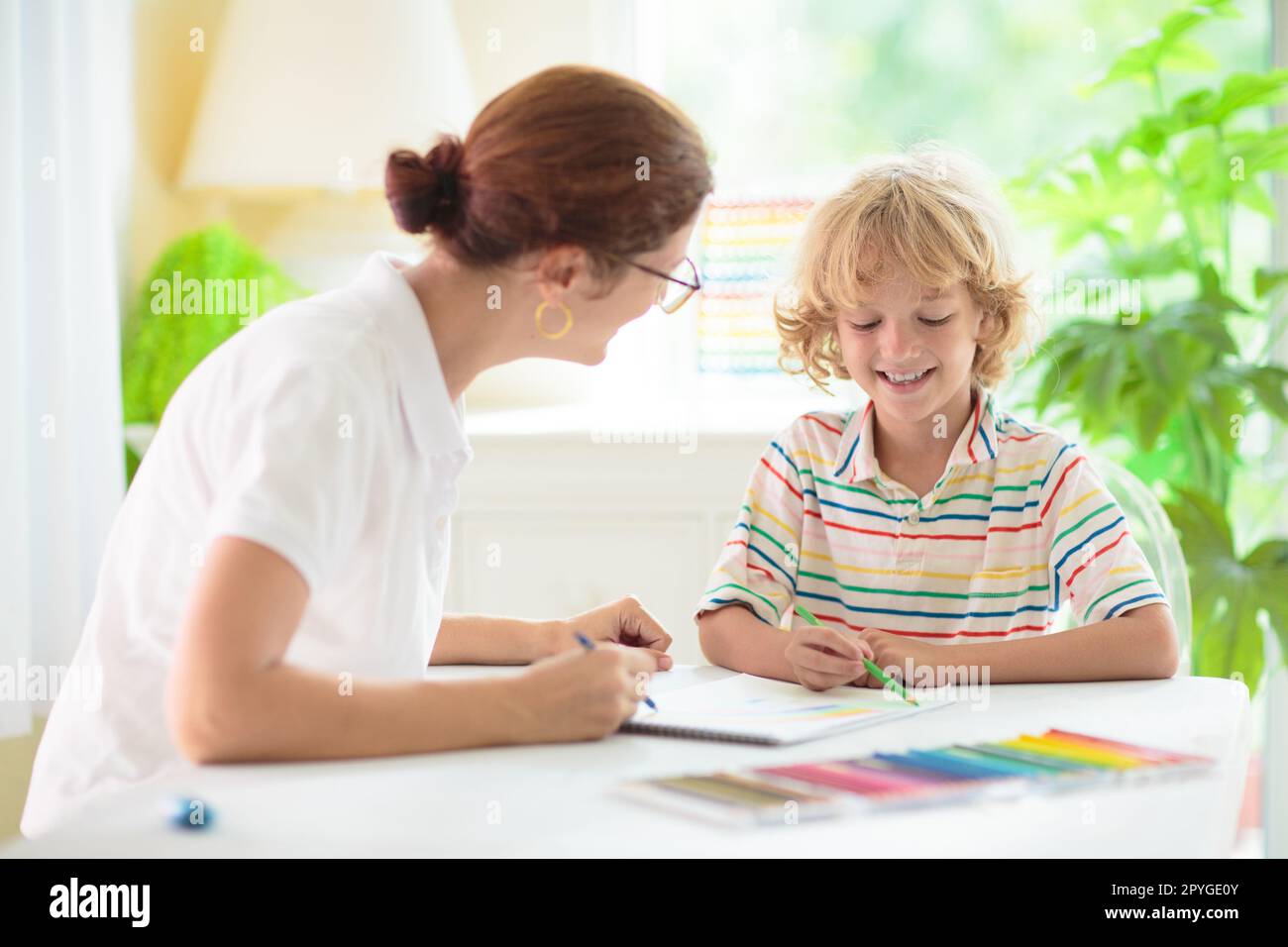 Child drawing. School kid painting a picture. Little boy with colorful ...