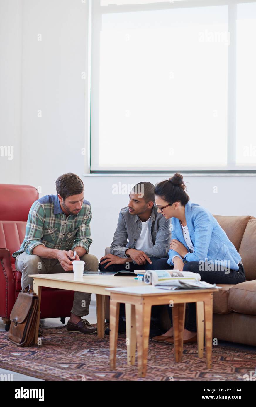 Talking design with the team. a diverse group of young designers ...