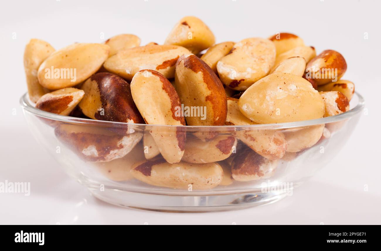 Glass bowl with roasted Brazil nuts Stock Photo - Alamy