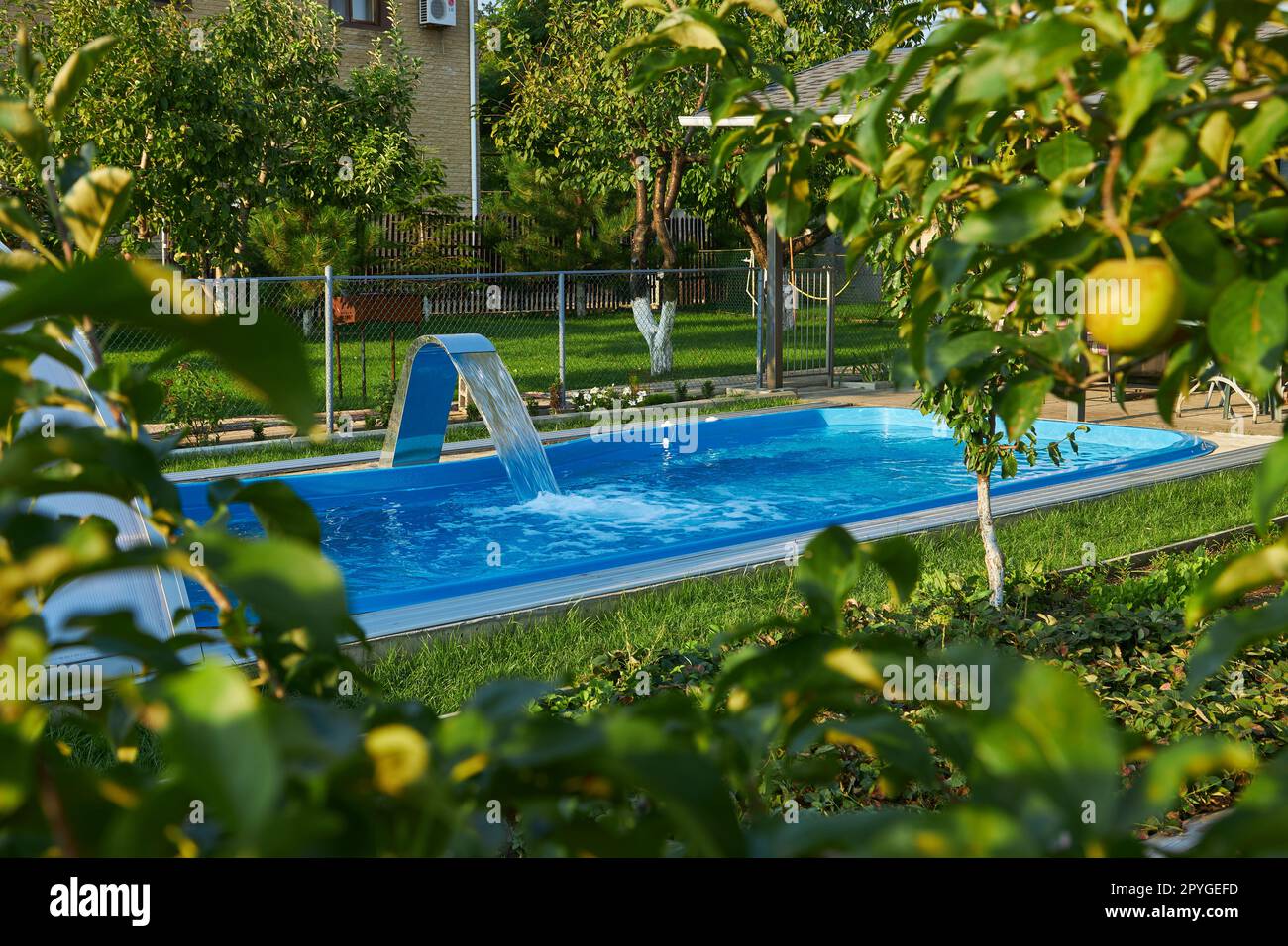 Residential swimming pool with view of the garden Stock Photo - Alamy