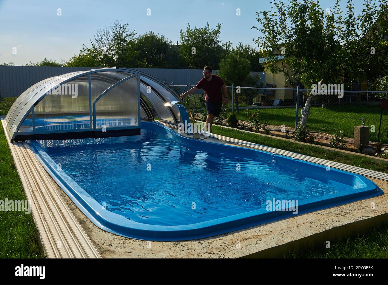 Residential swimming pool with view of the garden Stock Photo - Alamy