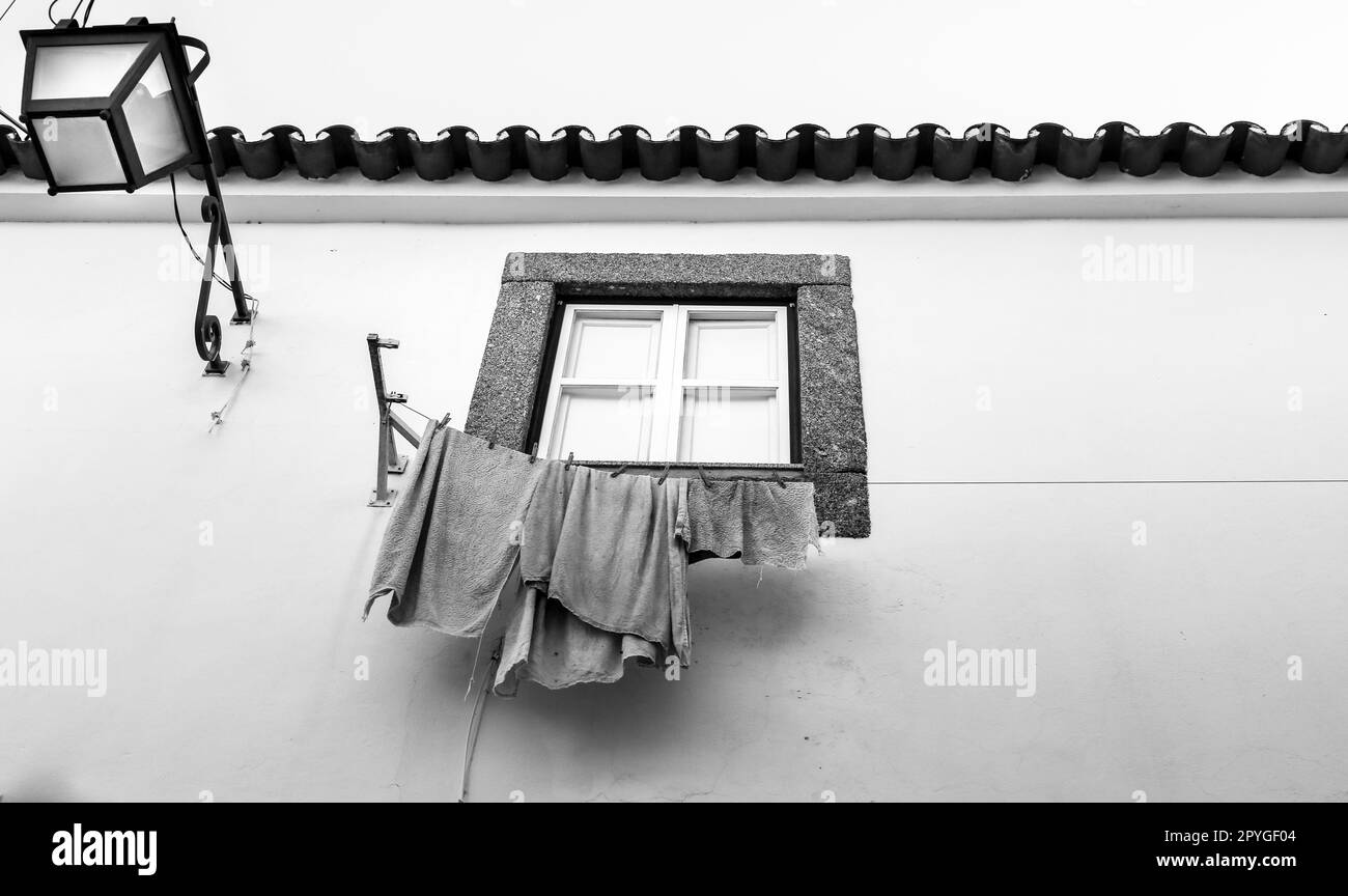 Typical Portuguese window with hanging clothes. Monochrome picture ...
