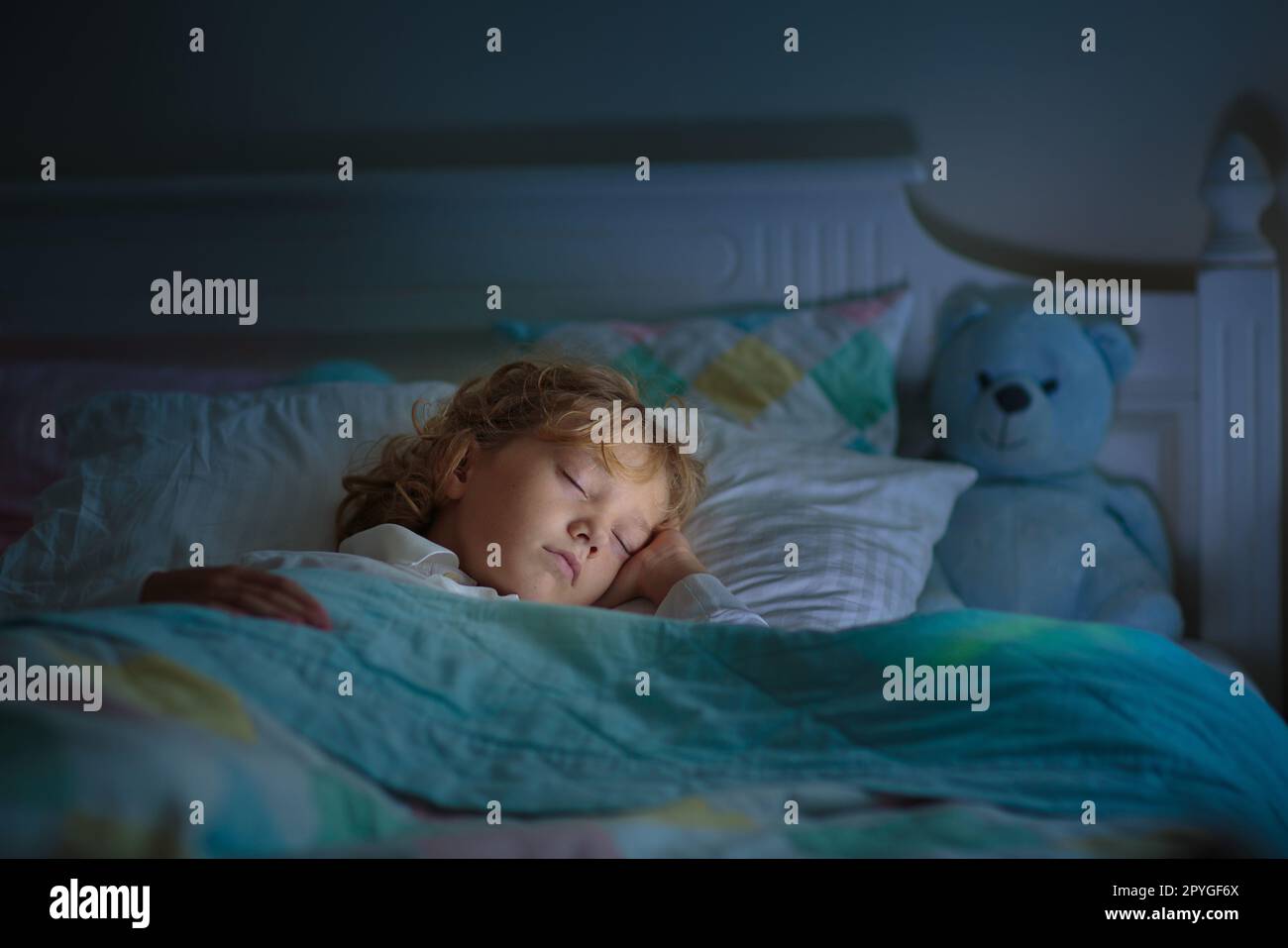 Child sleeping in dark bedroom. Little boy napping. Healthy night rest ...