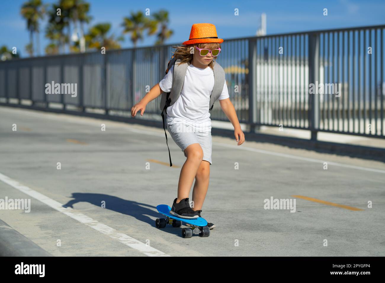 Kid on skateboard skating. Child skateboarder ride on skateboard in ...