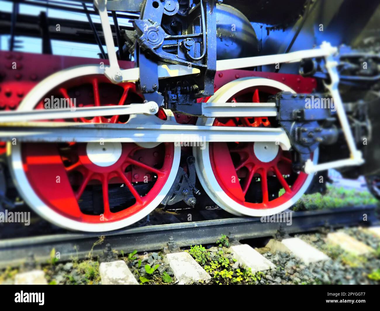 Retro vintage wheels of a locomotive or train close up. Red large heavy ...