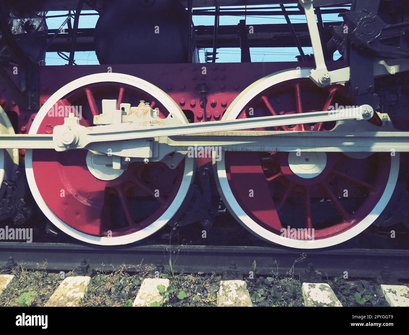 Retro vintage wheels of a locomotive or train close up. Red large heavy ...