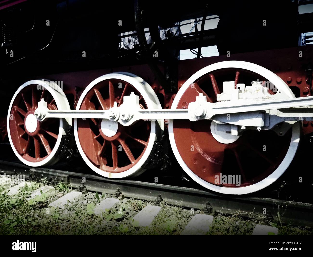 Retro vintage wheels of a locomotive or train close up. Red large heavy ...