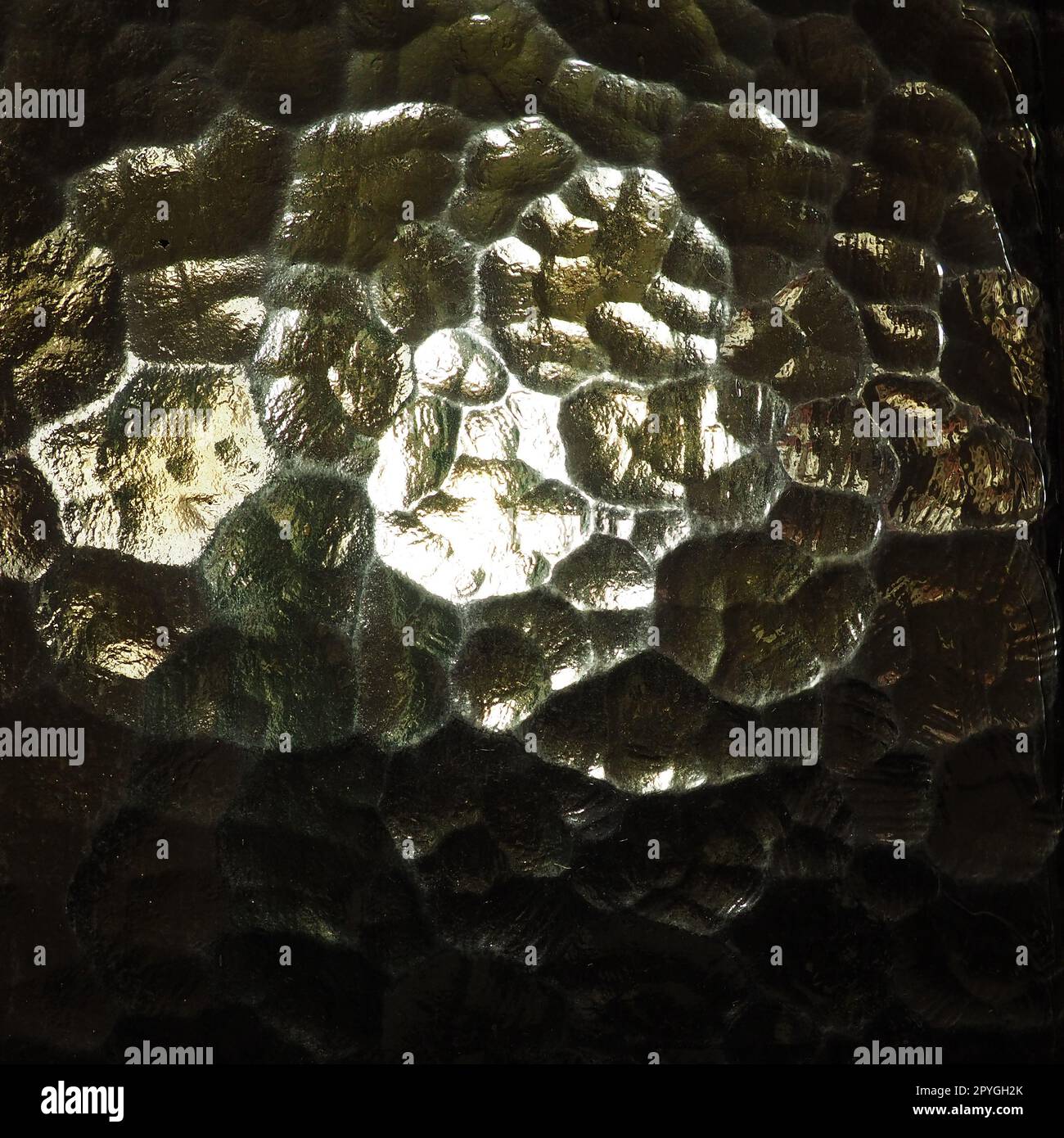 Corrugated glass, rear light source. Play of glare and reflections on a ...