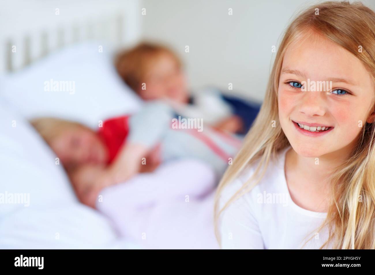 Smiling little girl with his family in blur background. Portrait of a ...