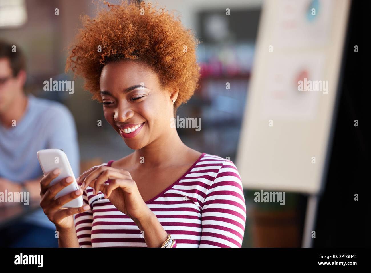 Success is just a text away. A young businesswoman using her phone in ...