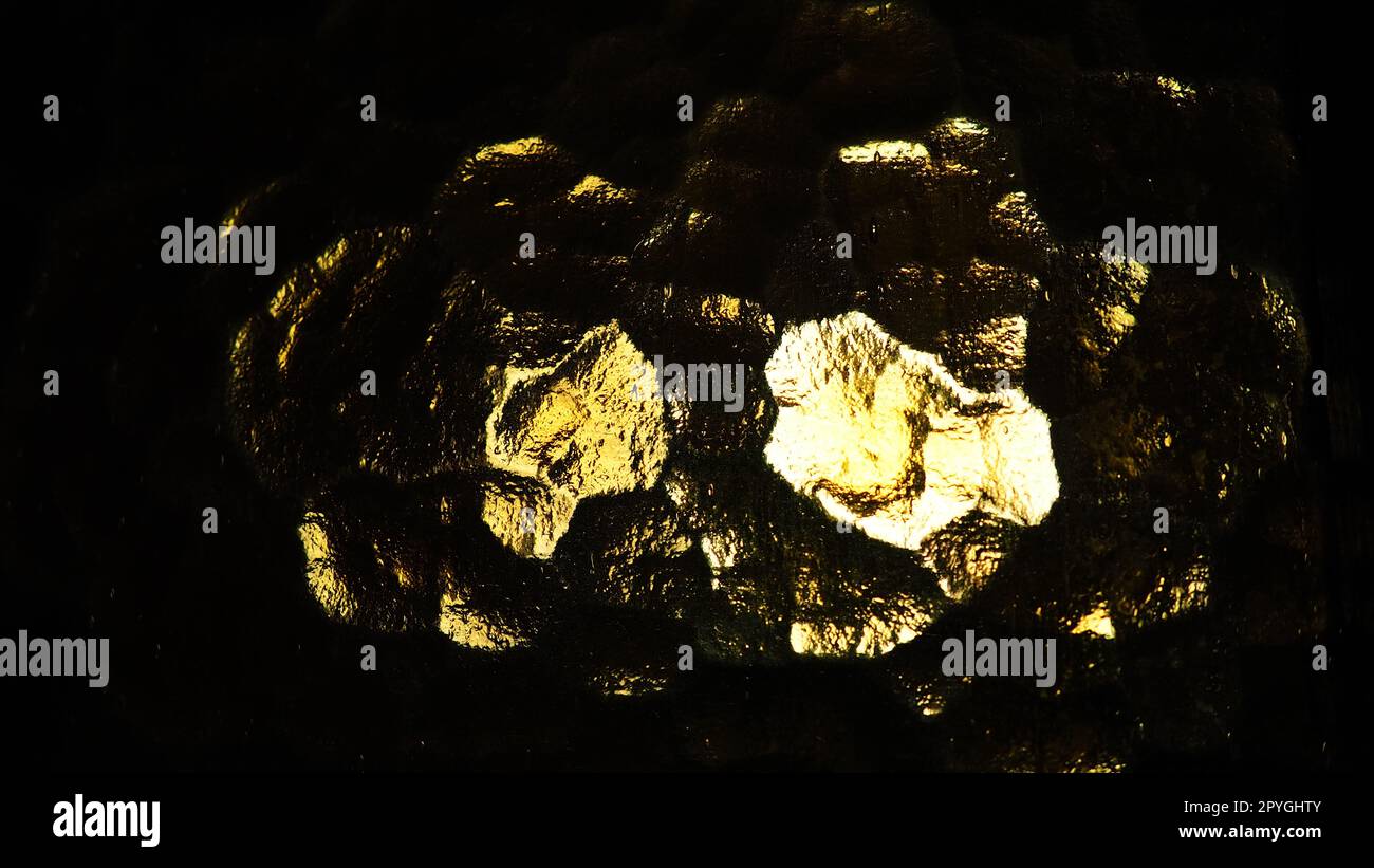 Corrugated glass, rear light source. Play of glare and reflections on a ...