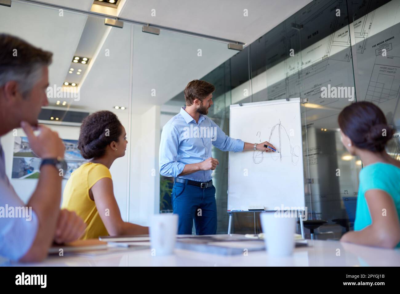 Presenting his great idea. a handsome young man giving a business ...