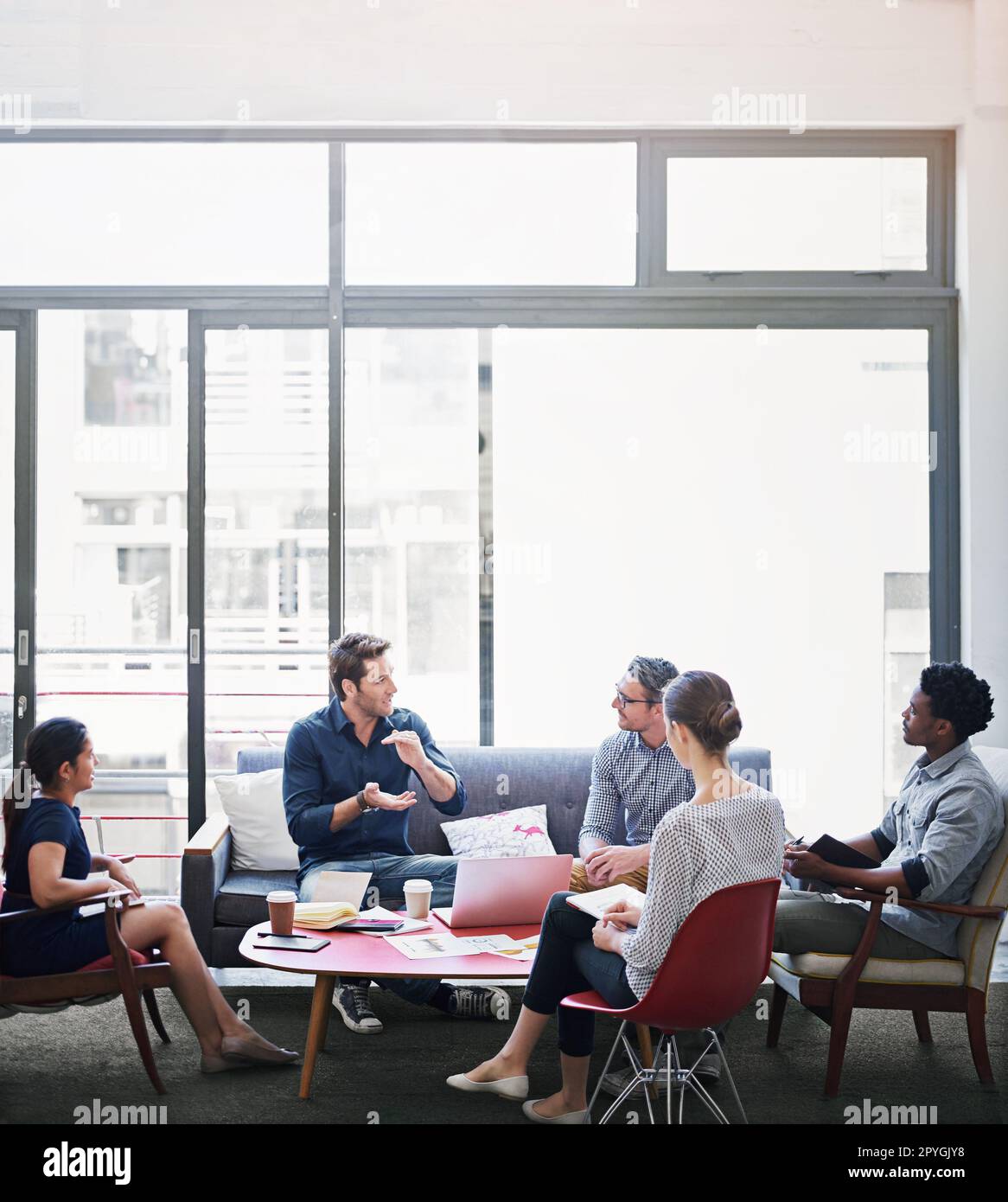 Creative minds at work. a group of coworkers in a meeting in an office ...