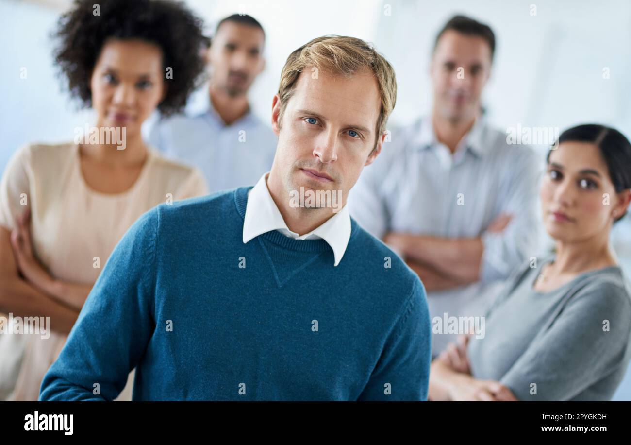 Team focus. Portrait of a group of diverse colleagues standing in an ...