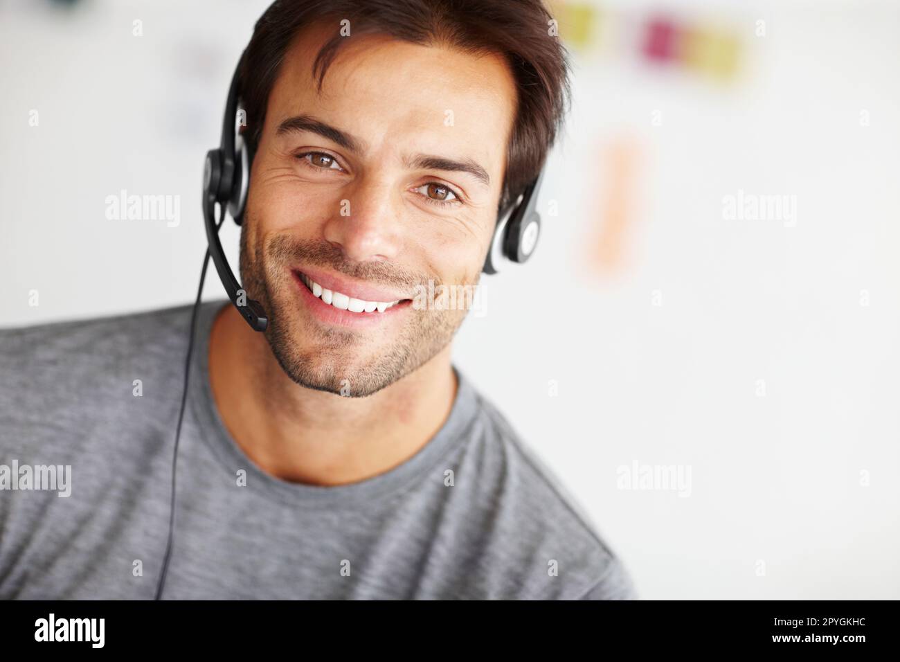 On the line to help. Closeup portrait of a handsome young man wearing a ...
