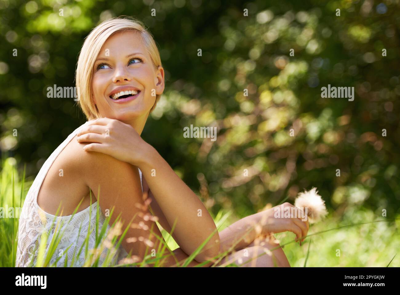 Thinking about nature. An attractive young woman sitting in an open ...