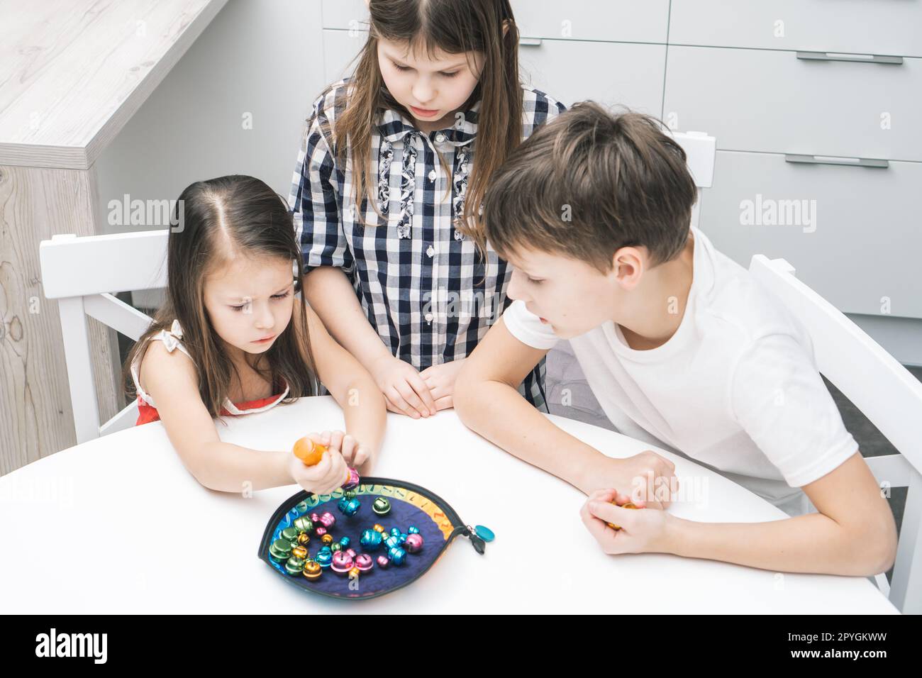 Cloudy looking children of girl and boy look at girl trying to catch ...