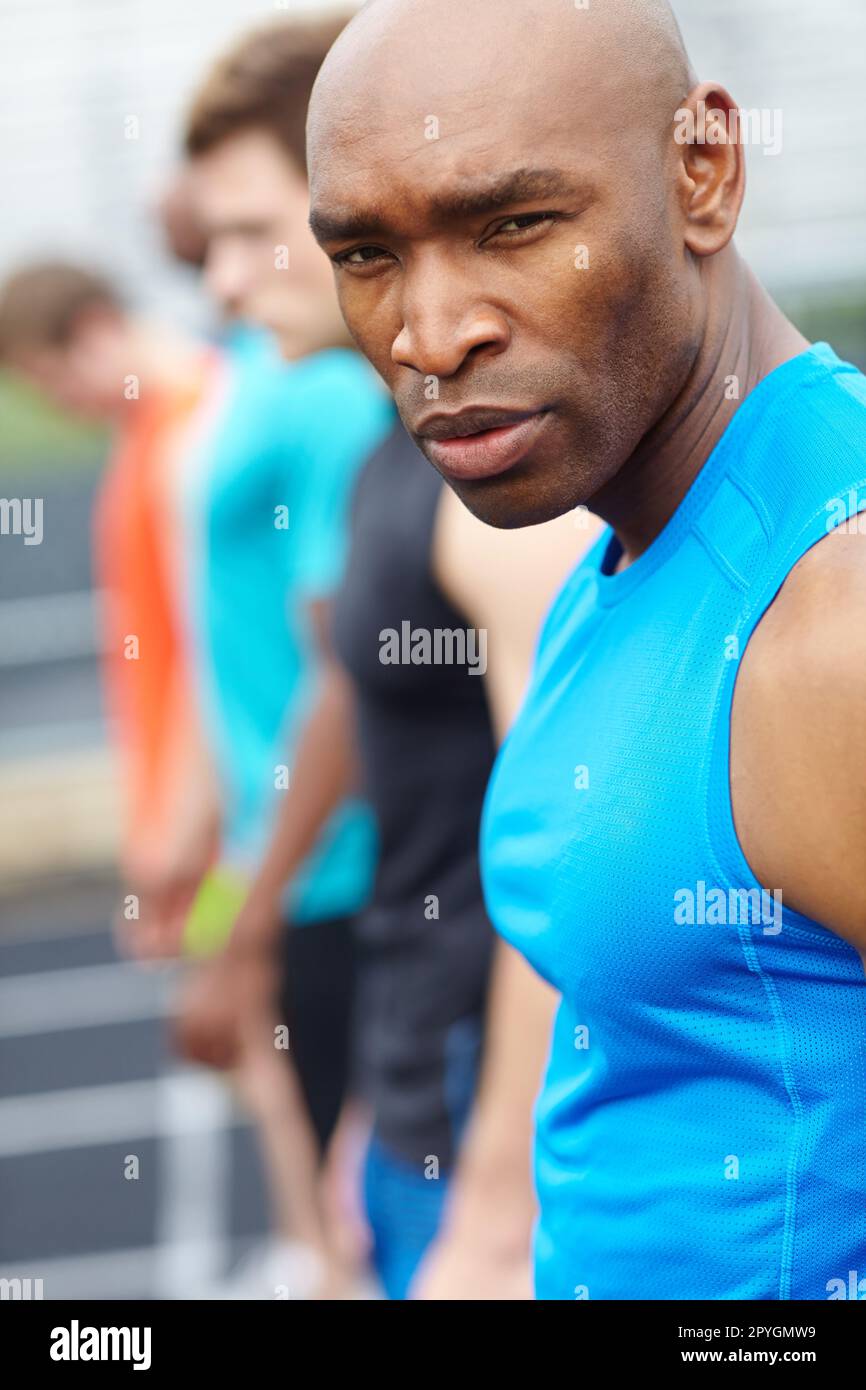 Its time to show what hes got. Close up side view of a male runner ...