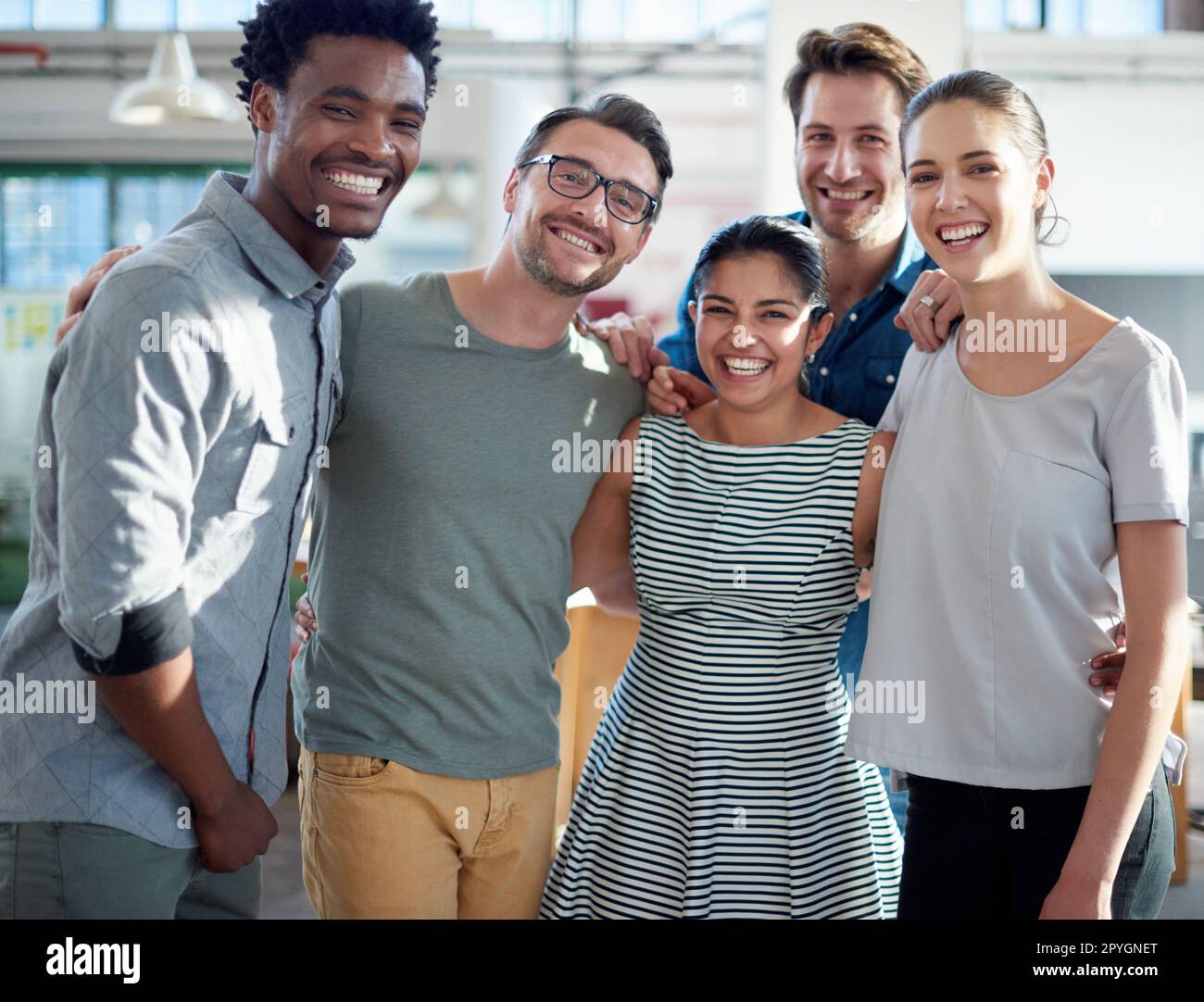 They love working together. Portrait of a group of colleagues standing ...