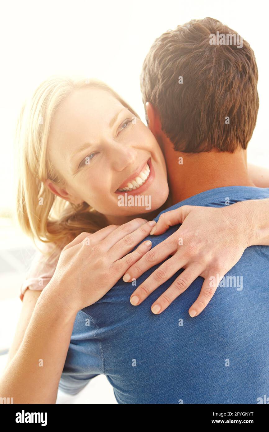 I love him so much. A happy woman hugging her boyfriend in the sunshine Stock Photo - Alamy
