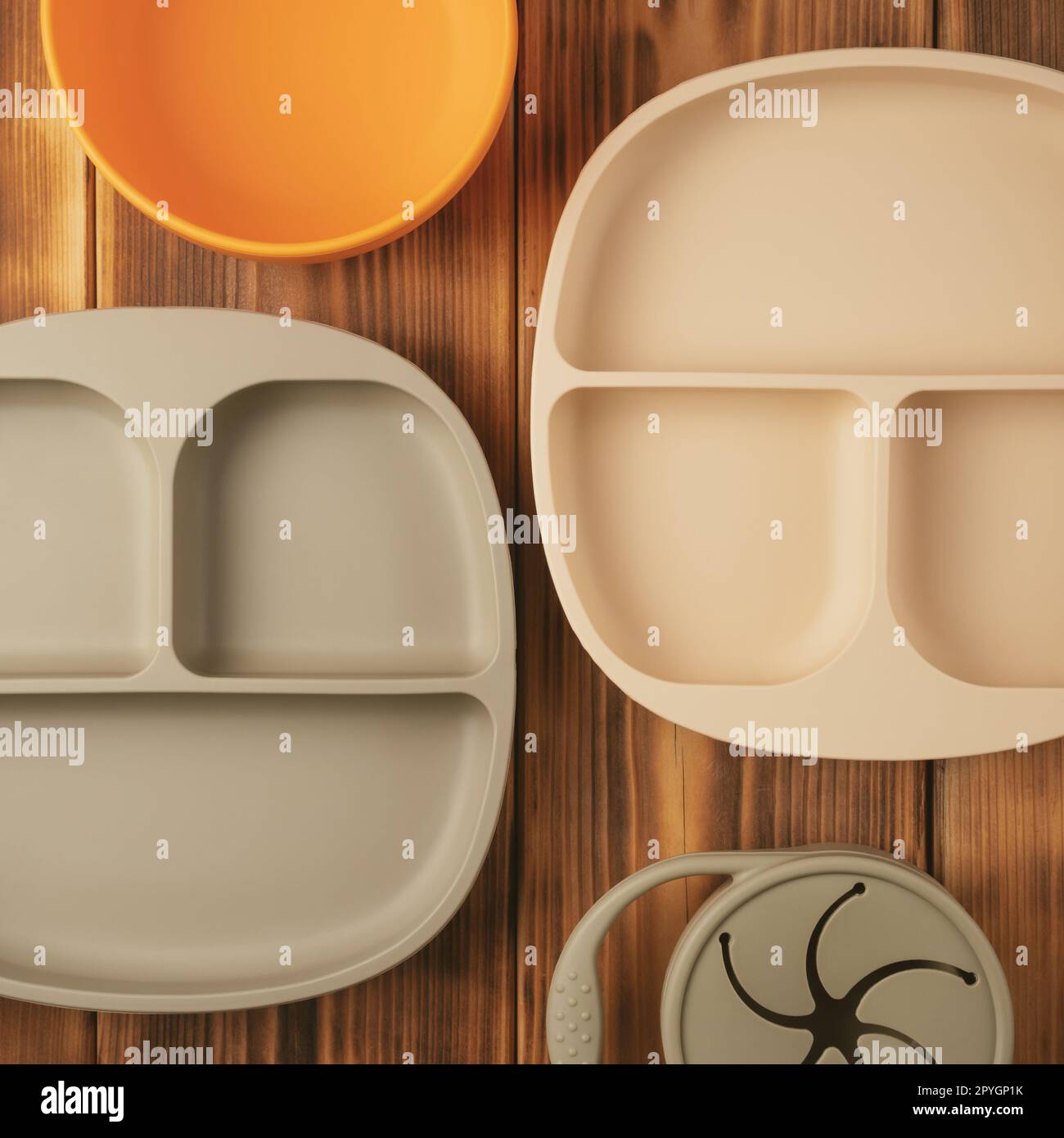 Modern colorful pastel silicone food trays, bowl and snack cup on brown ...