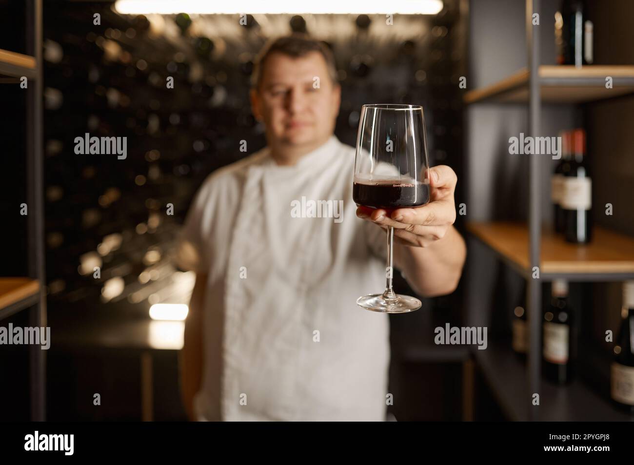 Successful male sommelier tasting flavor and checking wine quality ...