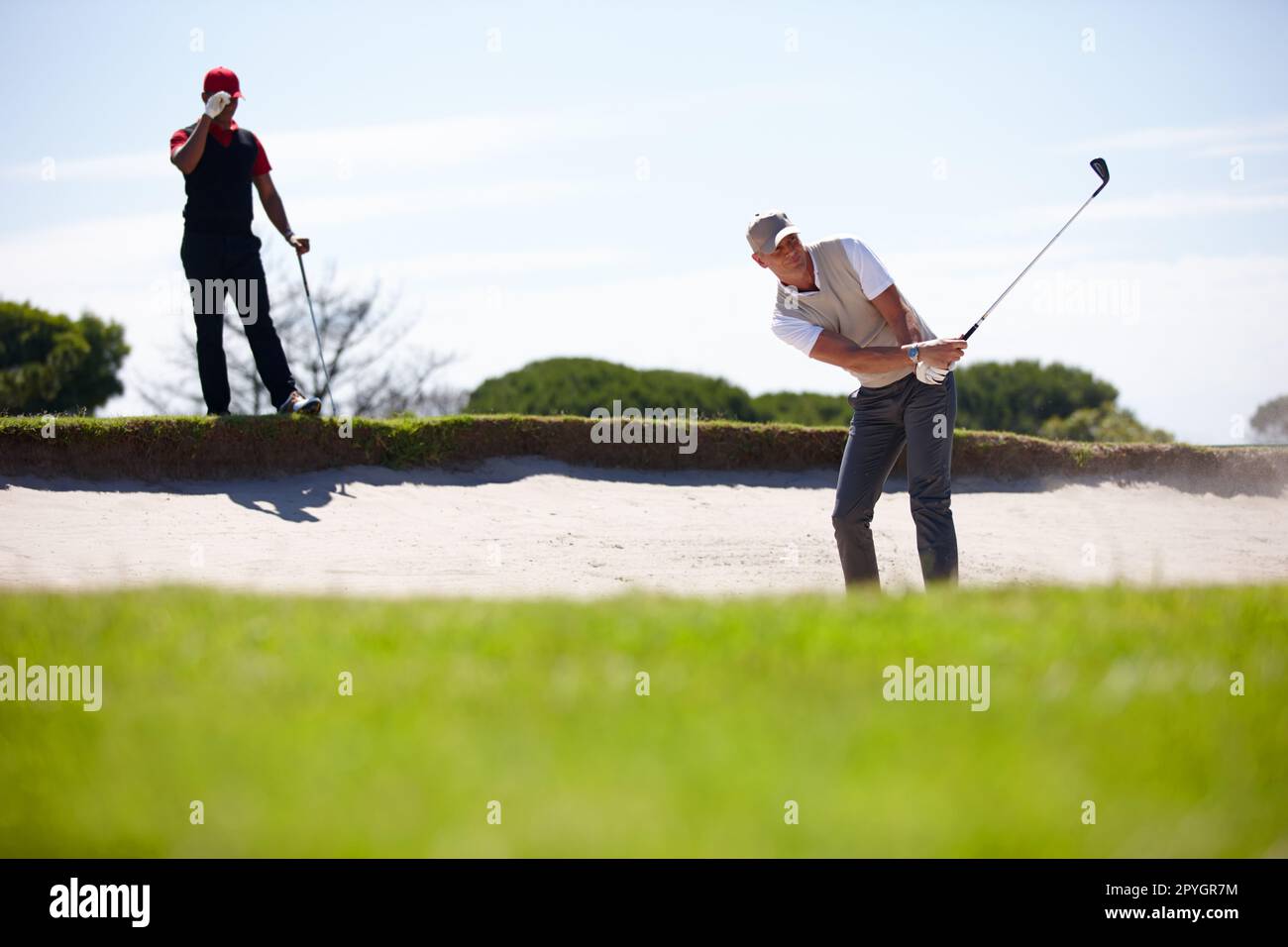 Getting into the swing of things. two handsome men playing a game of ...