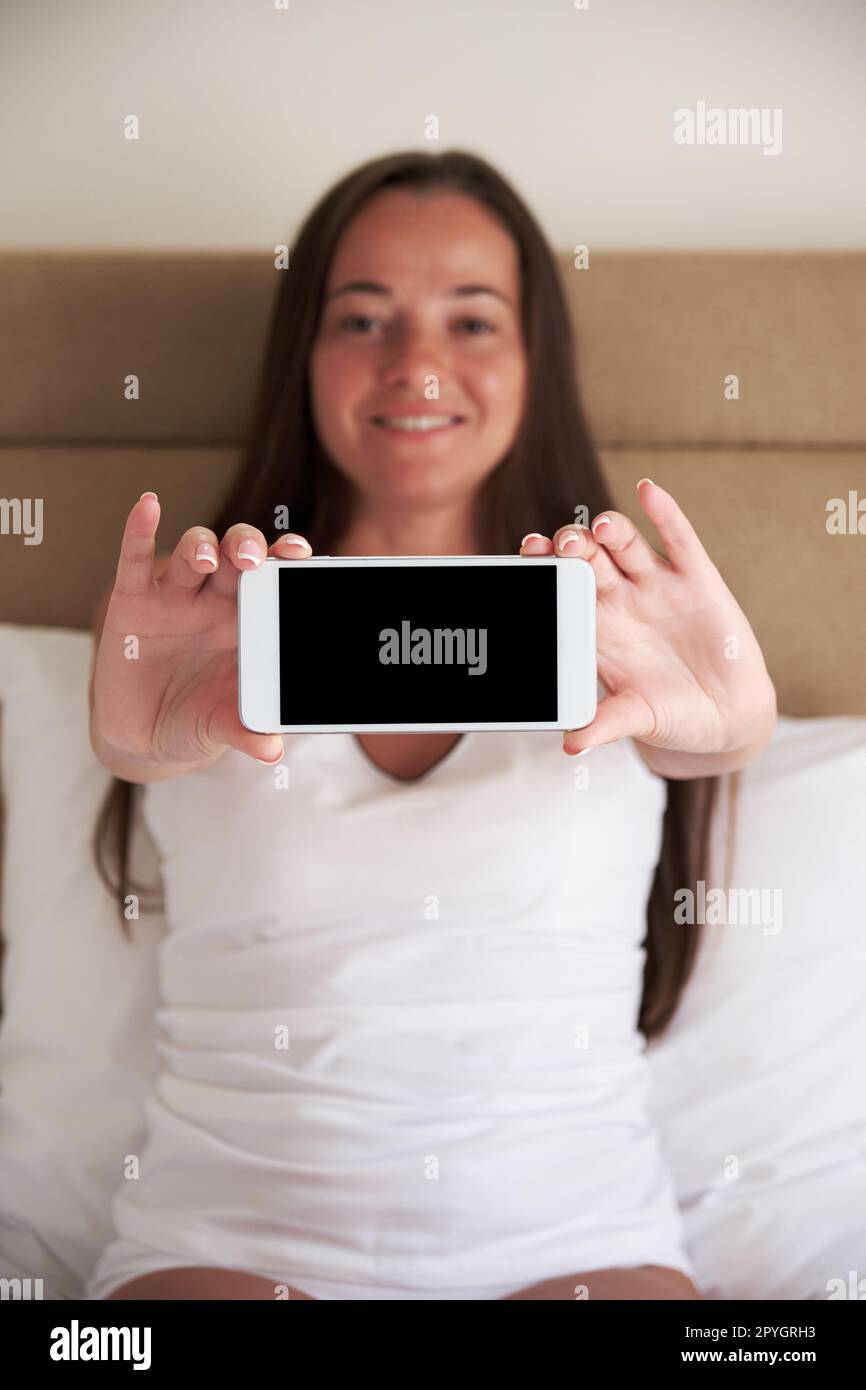 Happy woman demonstrates smartphone screen. Mobile app mockup. Template ...