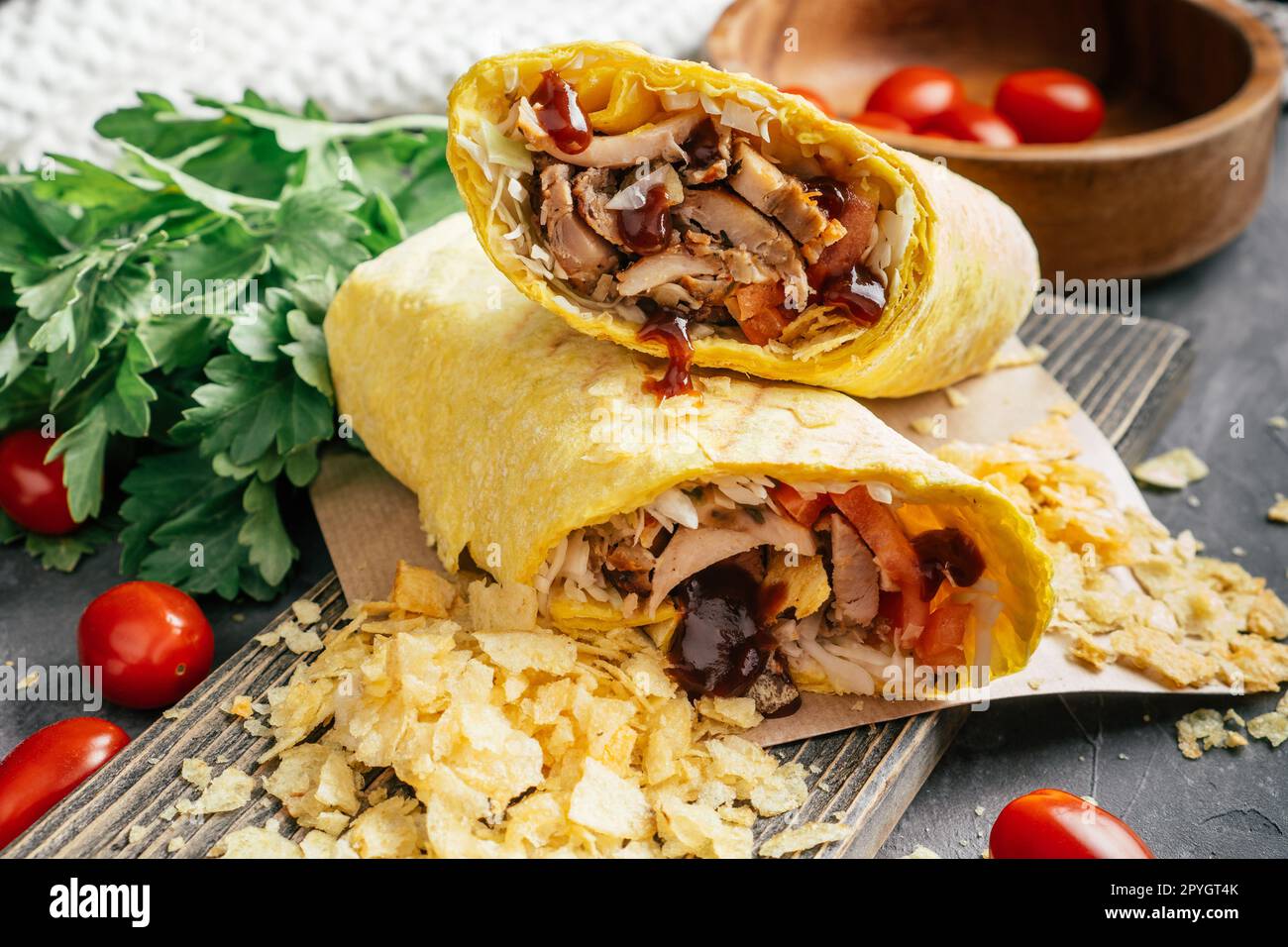 Crispy shawarma with chips, barbeque sauce, chicken in pita bread on ...