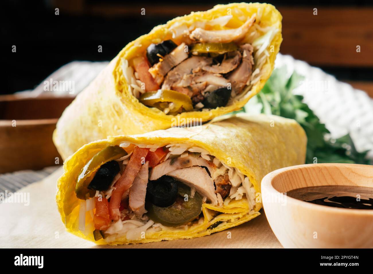 Mexican shawarma with hot sauce, jalapeno pepper, olives on wooden dark ...