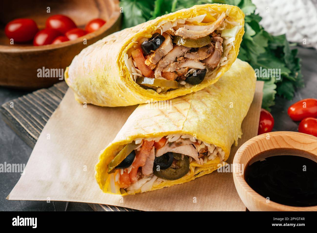 Mexican shawarma with hot sauce, jalapeno pepper, olives on wooden dark ...