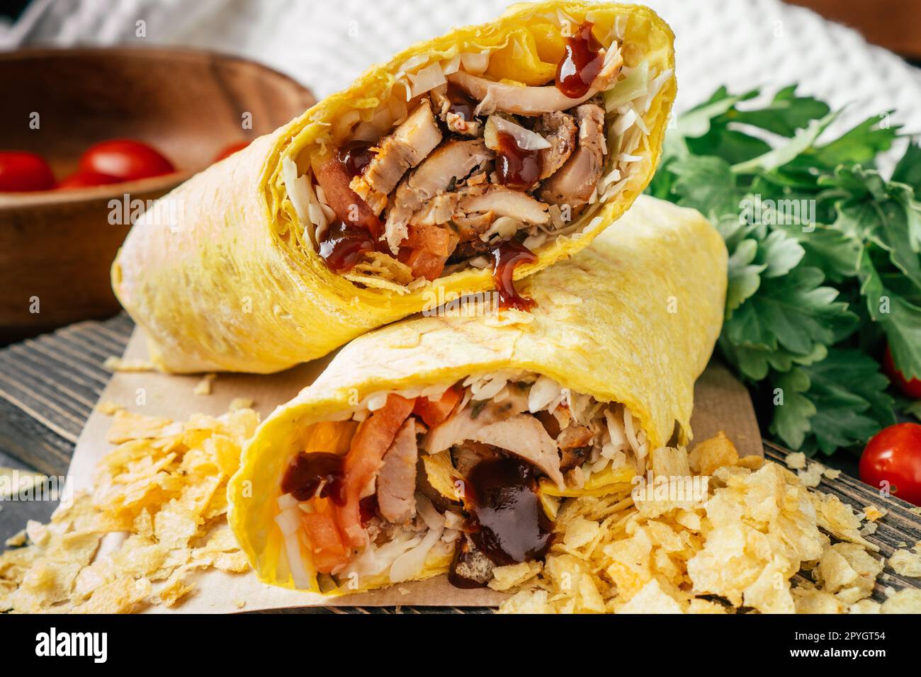 Crispy shawarma with chips, barbeque sauce, chicken in pita bread on ...