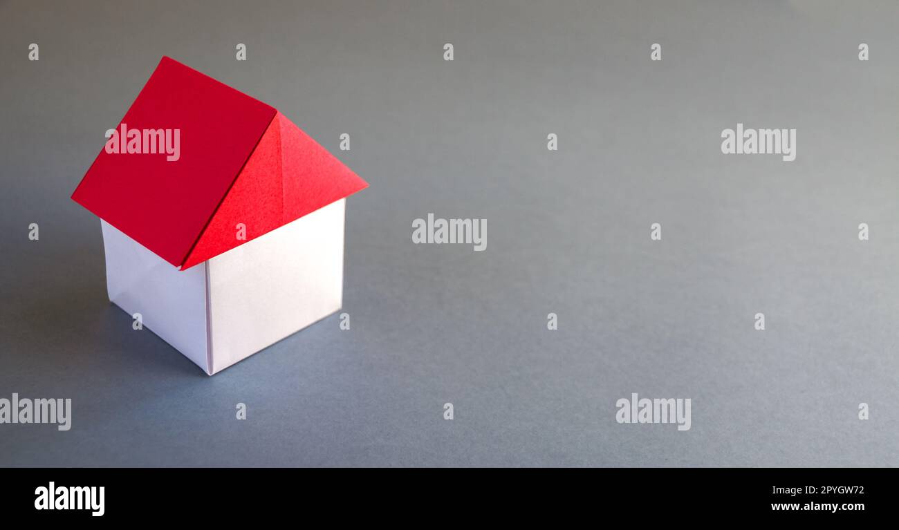 White and red paper house origami isolated on grey background Stock ...
