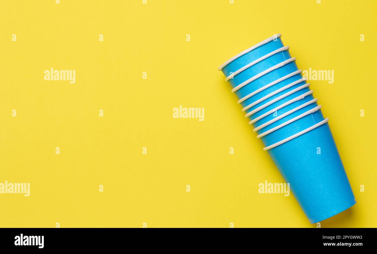 Disposable paper cups on yellow background, top view Stock Photo - Alamy