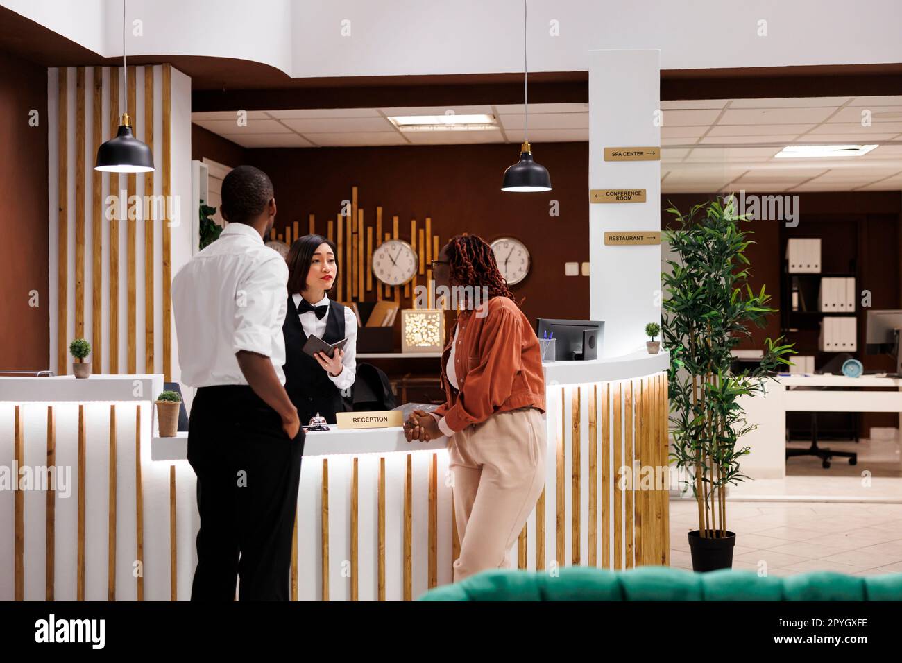 Female employee with registration form reviewing information before ...