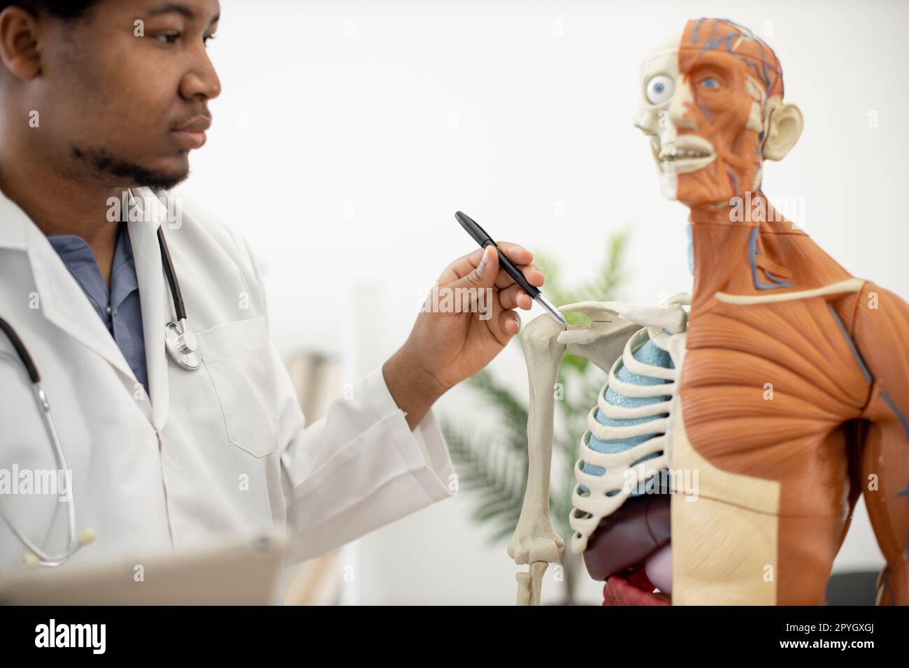 Close up view of multiethnic male with stethoscope marking joint of ...