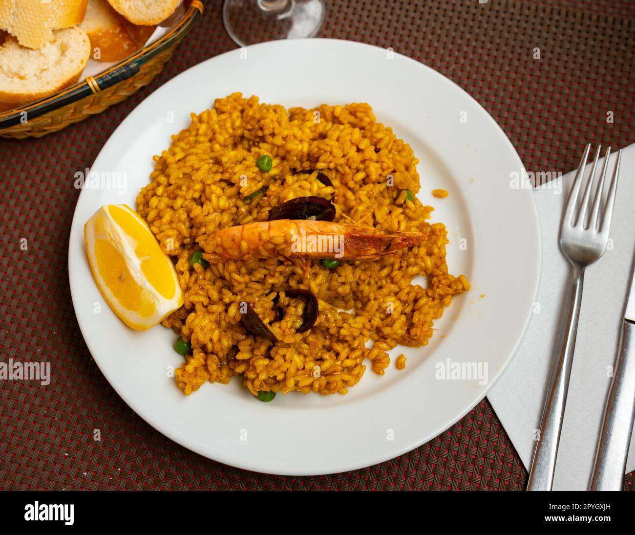 Spanish rice dish paella tinted with saffron. Prepared with olive oil ...
