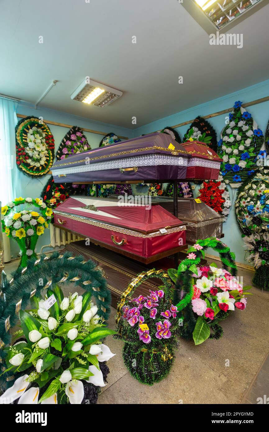 Interior of room with funeral accessories. Shop selling coffins ...
