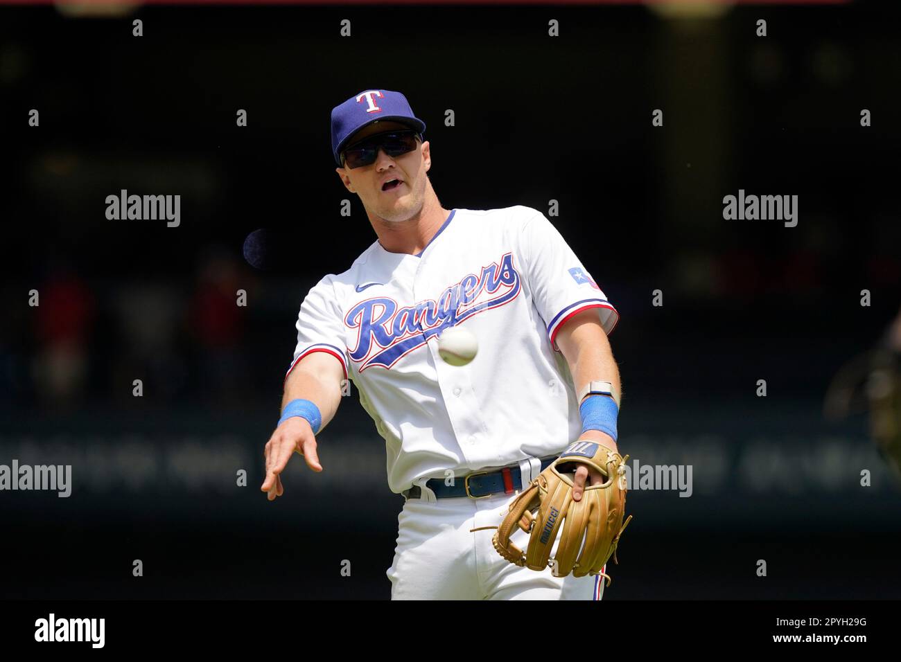 Texas Rangers third baseman Josh Jung tosses a baseball in Arlington ...