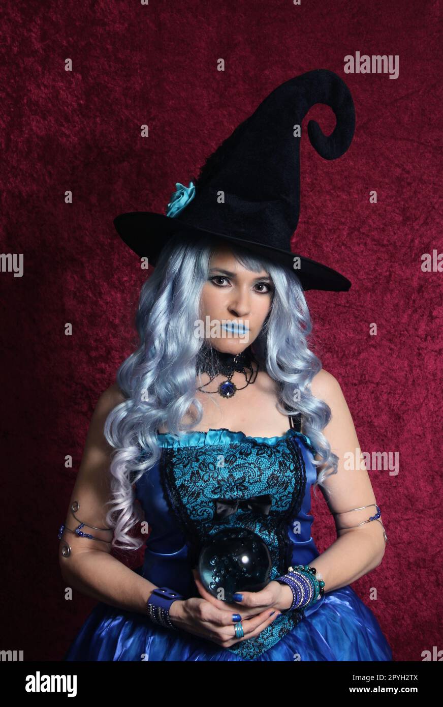 Woman Dressed as Blue Witch Holding Crystal Ball Stock Photo - Alamy