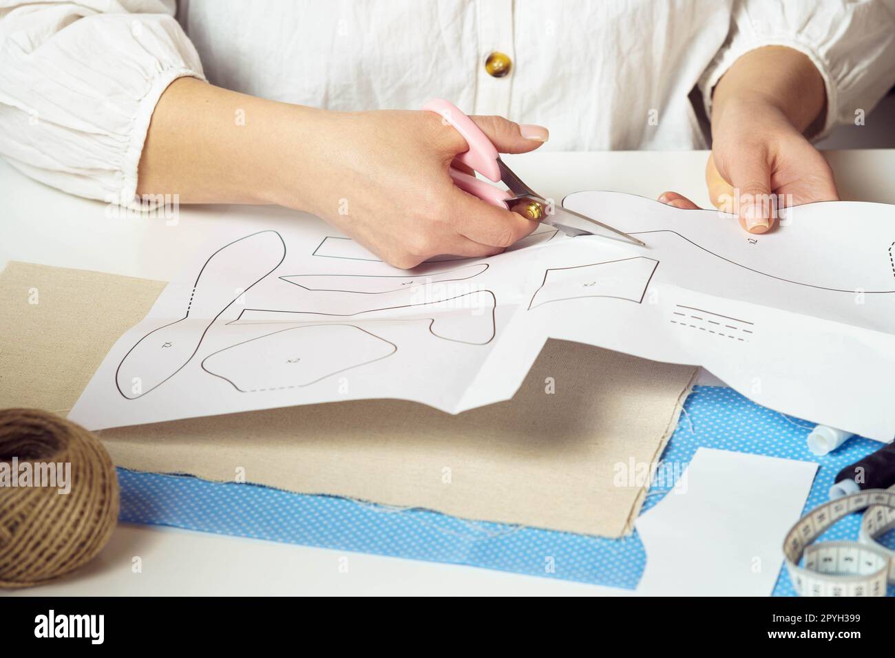Handcrafted do it yourself tutorial. Cropped female tailor hands ...