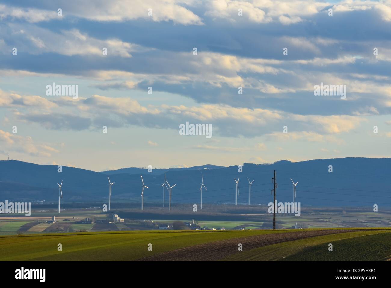 lot of windmills in a landscape with fields forest and houses with ...