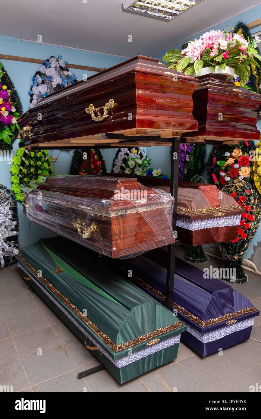 Interior of room with funeral accessories. Shop selling coffins ...