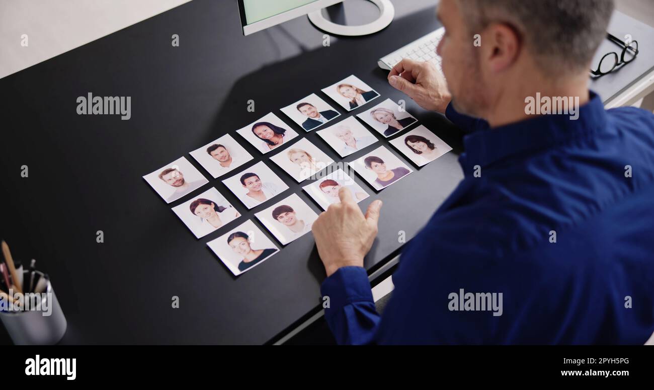 Selecting The Candidate Portrait Photo For Hiring Stock Photo - Alamy