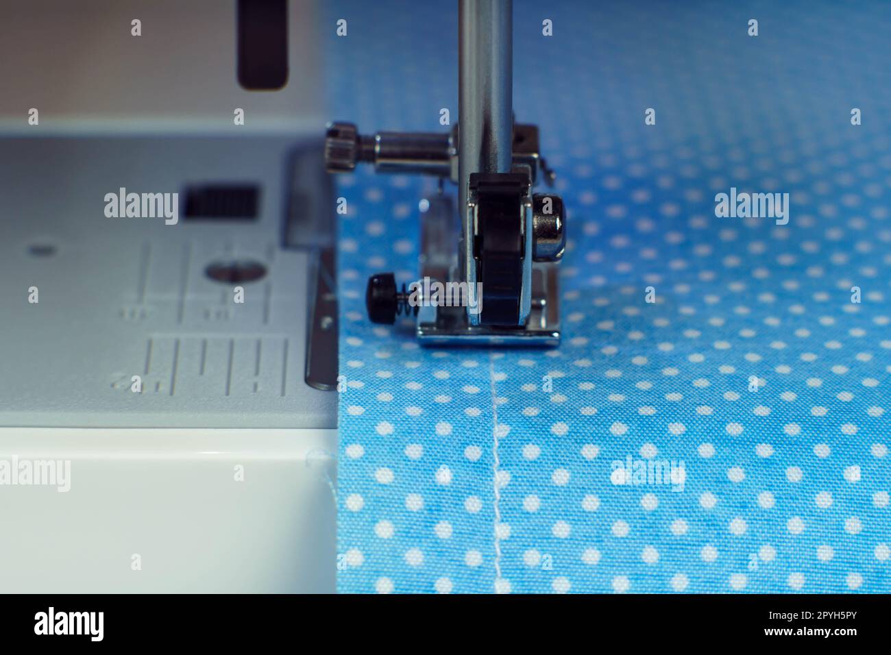 Close up sewing machine steel part with needle, pressure foot stitching ...