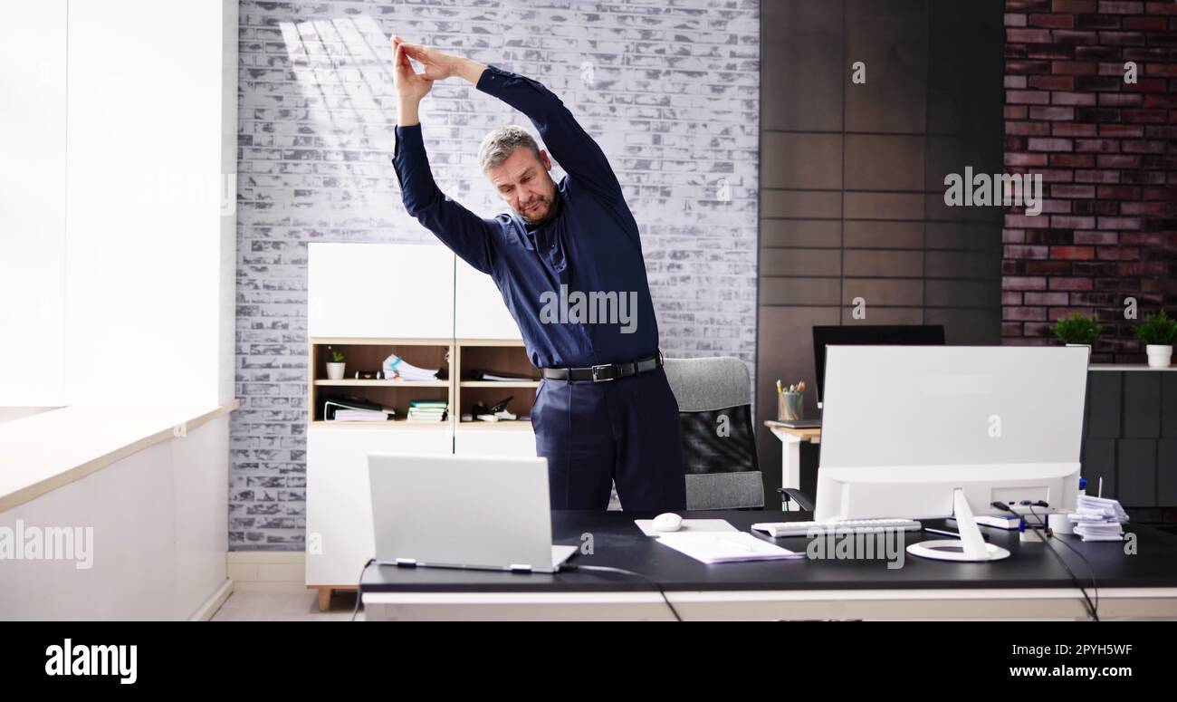 Arms Stretch Exercise Standing Near Desk Stock Photo - Alamy
